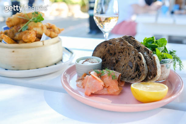 Beer battered fish and smoked trout with dark rye at a café in Palm ...