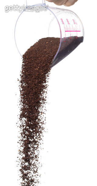Coffee powder fall down pour in measured cup, Coffee crushed float ...