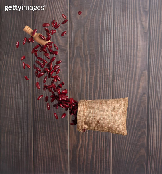 Red Bean flying explosion in sack bag, red grain beans explode abstract ...