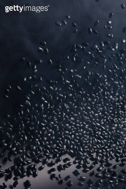 Black Bean flying explosion, black grain beans explode abstract cloud ...