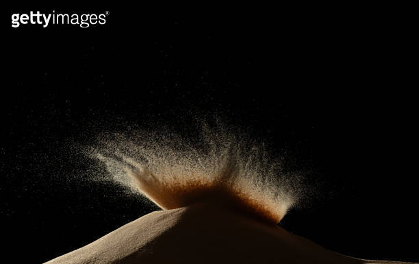 Deep impact on sand hill and splash all over area. Sand dune hill over ...