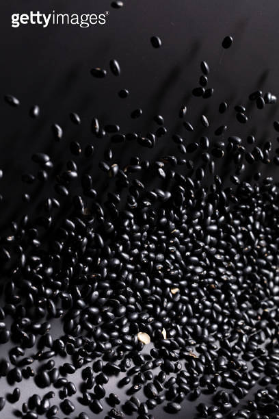 Black Bean flying explosion, black grain beans explode abstract cloud ...