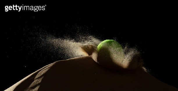 Tennis ball throw hit sand soil and Deep impact on sand hill and splash ...