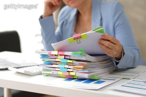 Senior businesswoman is stressed from doing too much paperwork ...