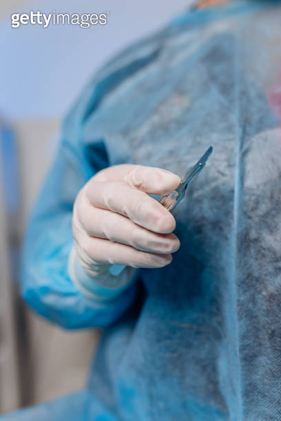 Professional doctor surgeon holding scalpel in operation room at ...