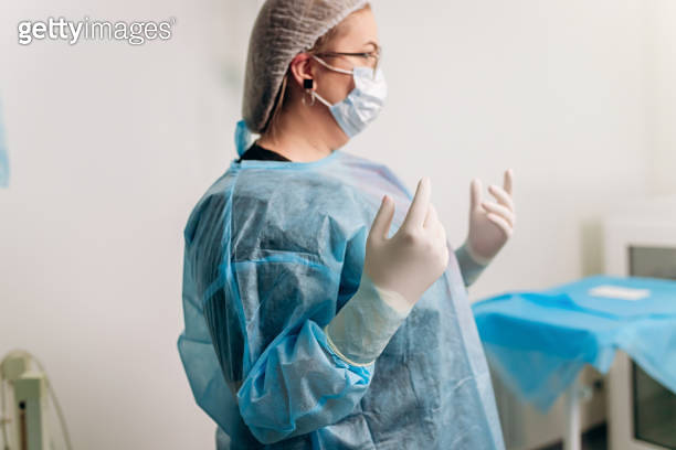 Doctor preparation for surgical operation in hospital. Medical workers ...