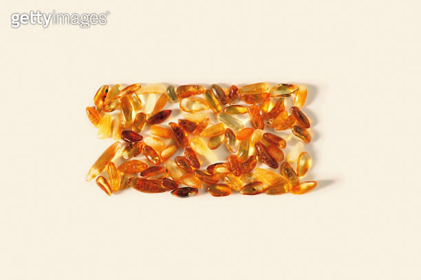 Nature gemstone amber stones, glare shadows, yellow orange colored on ...