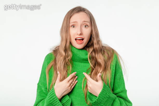 Portrait of a surprised woman pointing at herself, self-promoting ...