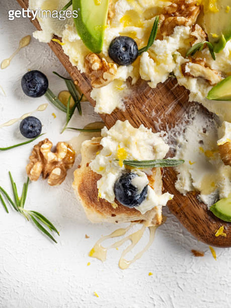 Cream on cutting board. Cream board topped with avocado, blueberry ...