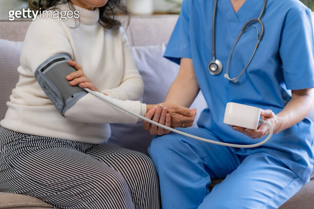 Female doctor check health and measures blood pressure of senior ...