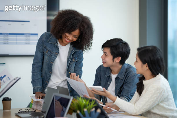 Group of creative young Asian business people are meeting to exchange ...