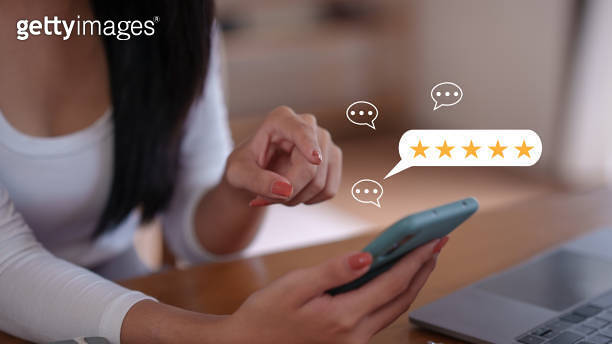 Customer reviews in mobile phone give 5 star. Woman using a smartphone ...