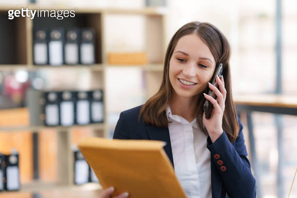 Beautiful woman lawyer talking on the phone with client about the ...