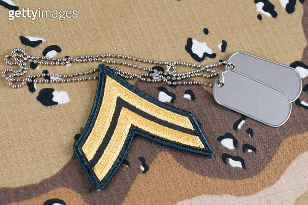 US ARMY Corporal rank patch and dog tags on desert camouflage uniform ...