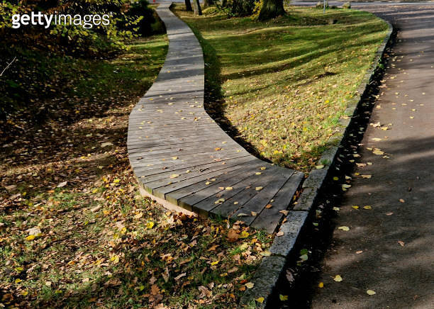 floating walkway made of wooden planks, pier, narrow curved paths on ...