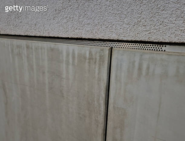 cladding of the house consists of concrete slabs with gaps with a ...