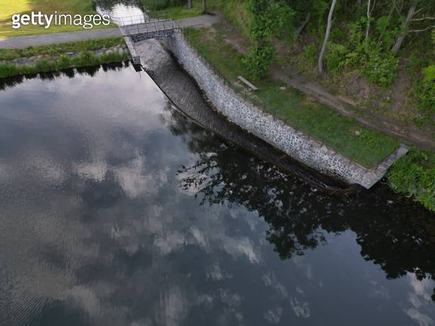 bridge over safety spillway of the dam. stone bridge with natural ...