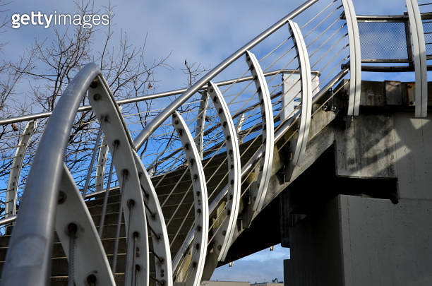staircase and wide pedestrian bridge with perforated metal floor ...