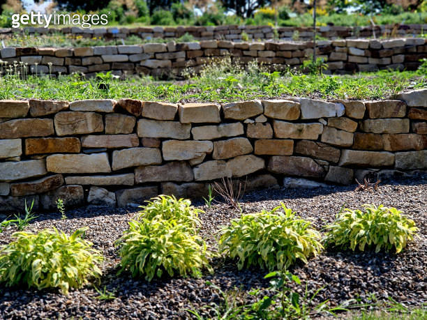 the dry wall serves as a terrace terrace for the garden, where it holds ...