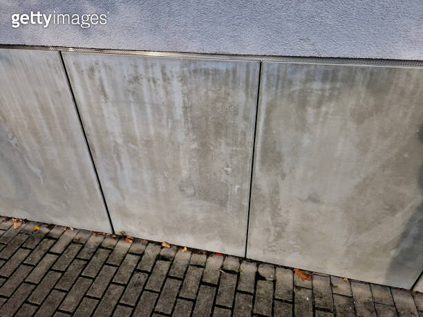 cladding of the house consists of concrete slabs with gaps with a ...