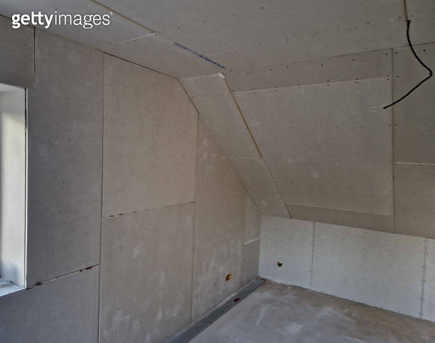 installation of a plasterboard ceiling. plaster is glued with paper and ...