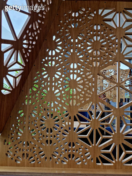 the partition between the tables in the restaurant is made of a plywood ...