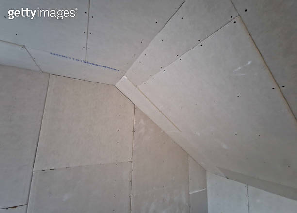 installation of a plasterboard ceiling. plaster is glued with paper and ...