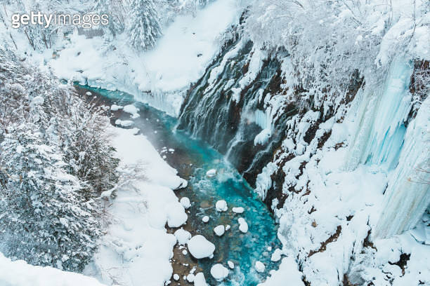 Shirahige Waterfall with Snow in winter, Biei river flow into Blue Pond ...