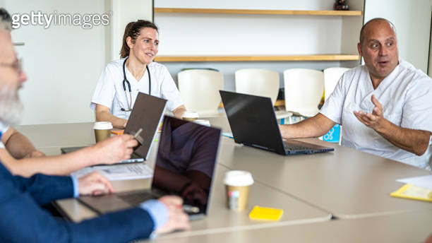 Moment of technical meeting in a medical clinic between doctors and ...