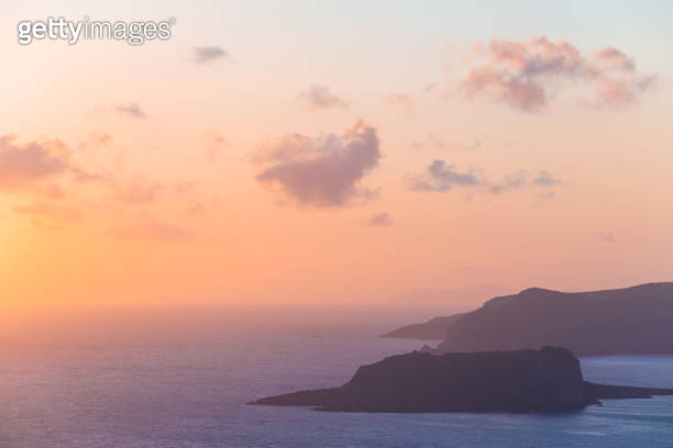 Pink foggy sunset at Santorini island, Greece. View of the sea and ...