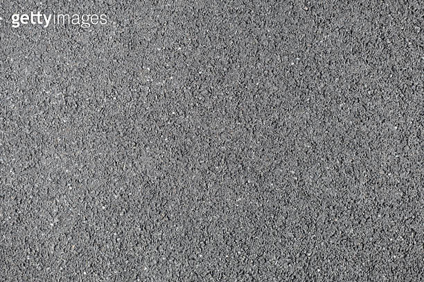 A frame filled with the textured surface of dry asphalt, showcasing the ...