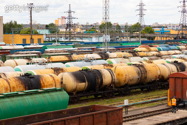 Tanks with fuel, wagons with cargo at a freight railway station ...