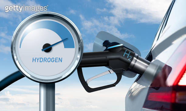 Close up of fuel cell car with connected hydrogen fueling nozzle and ...