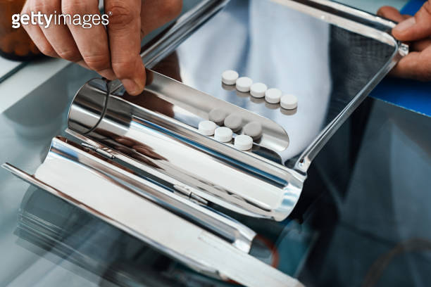 Pharmacist prepare pills in qualified counting tray by prescription at ...