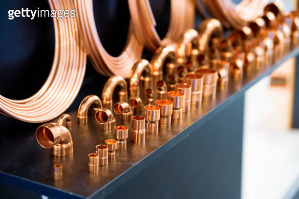 Copper tubes, copper corners and connections. Shallow depth of field ...