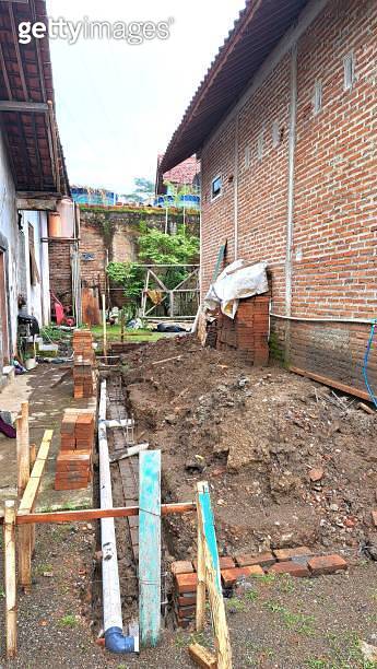 the process of building house walls and water channels, suitable for ...