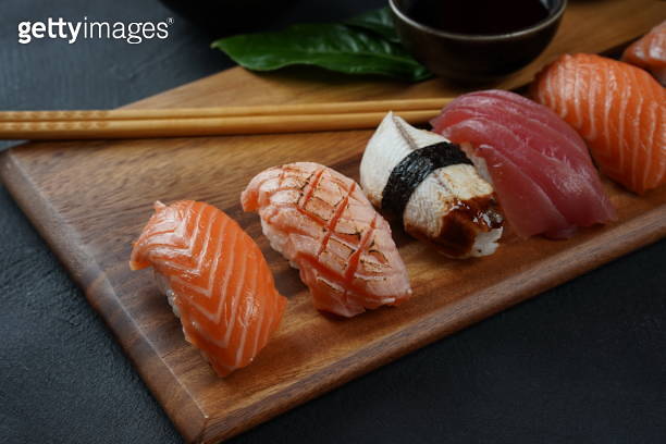 Japanese traditional Cuisine - Set of Nigiri sushi topped with sake ...