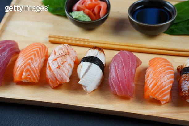 Japanese traditional Cuisine - Set of Nigiri sushi topped with sake ...