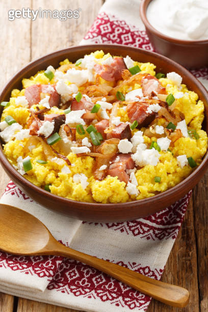 Delicious traditional Ukrainian banosh closeup on the bowl. Vertical ...