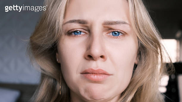 Portrait of crying grieving woman of 30 years. Grimace of sadness with ...