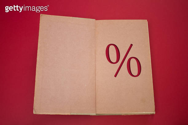 Percentage Sign in opened book with vintage, natural patterns old ...