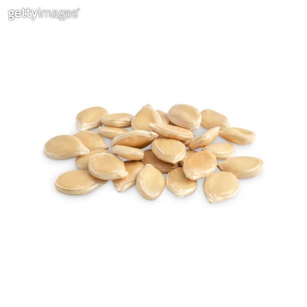 Heap of raw dried unshelled edible pumpkin seeds used as snack isolated ...