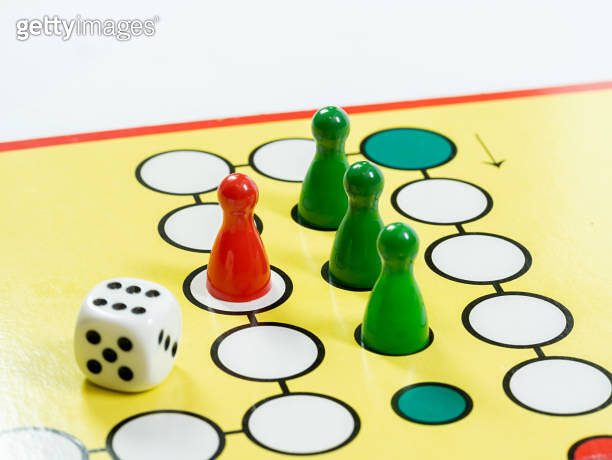 A classic generic board game with colorful game pieces and game dice on ...