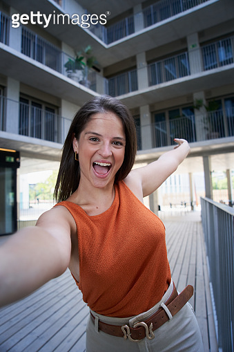 POV Vertical selfie outside of a cheerful smiling young Caucasian woman ...