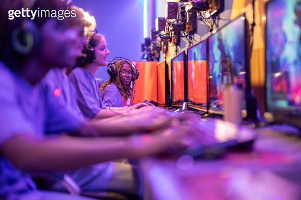 Diverse team of Caucasian professional gamers with players of African ...