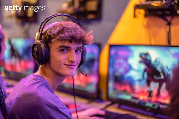 Caucasian man gamer looking at camera while playing video games with ...