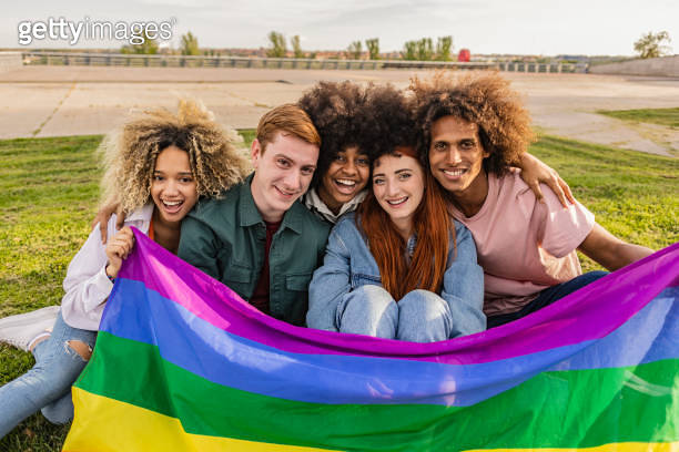 Group of young activist for lgbt rights with rainbow flag, transgenders ...