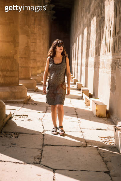 Portrait of a young brunette on the columns of the Edfu Temple near the ...