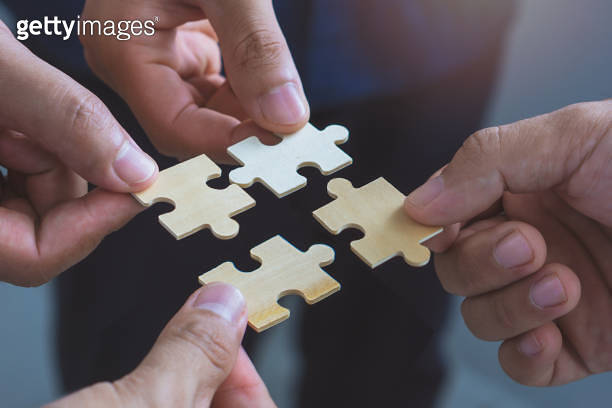 Unity concept.Business poeple merging jigsaw puzzle togather to ...