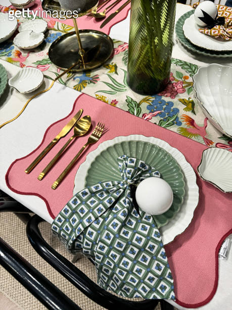 Close-up image of dining table place settings with scalloped dinner ...